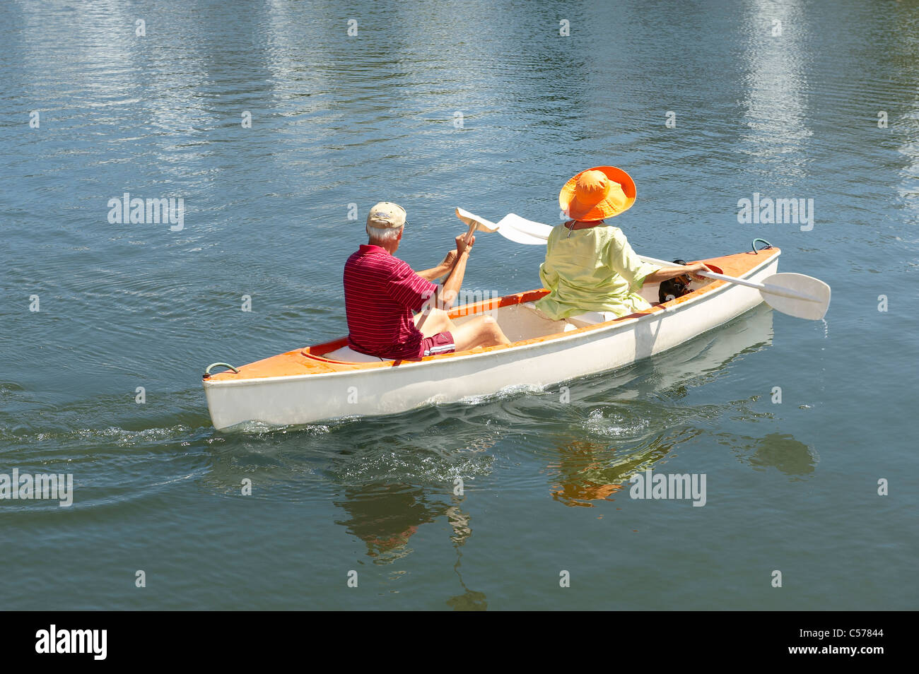 Older couple rowing canoe on lake Stock Photo - Alamy
