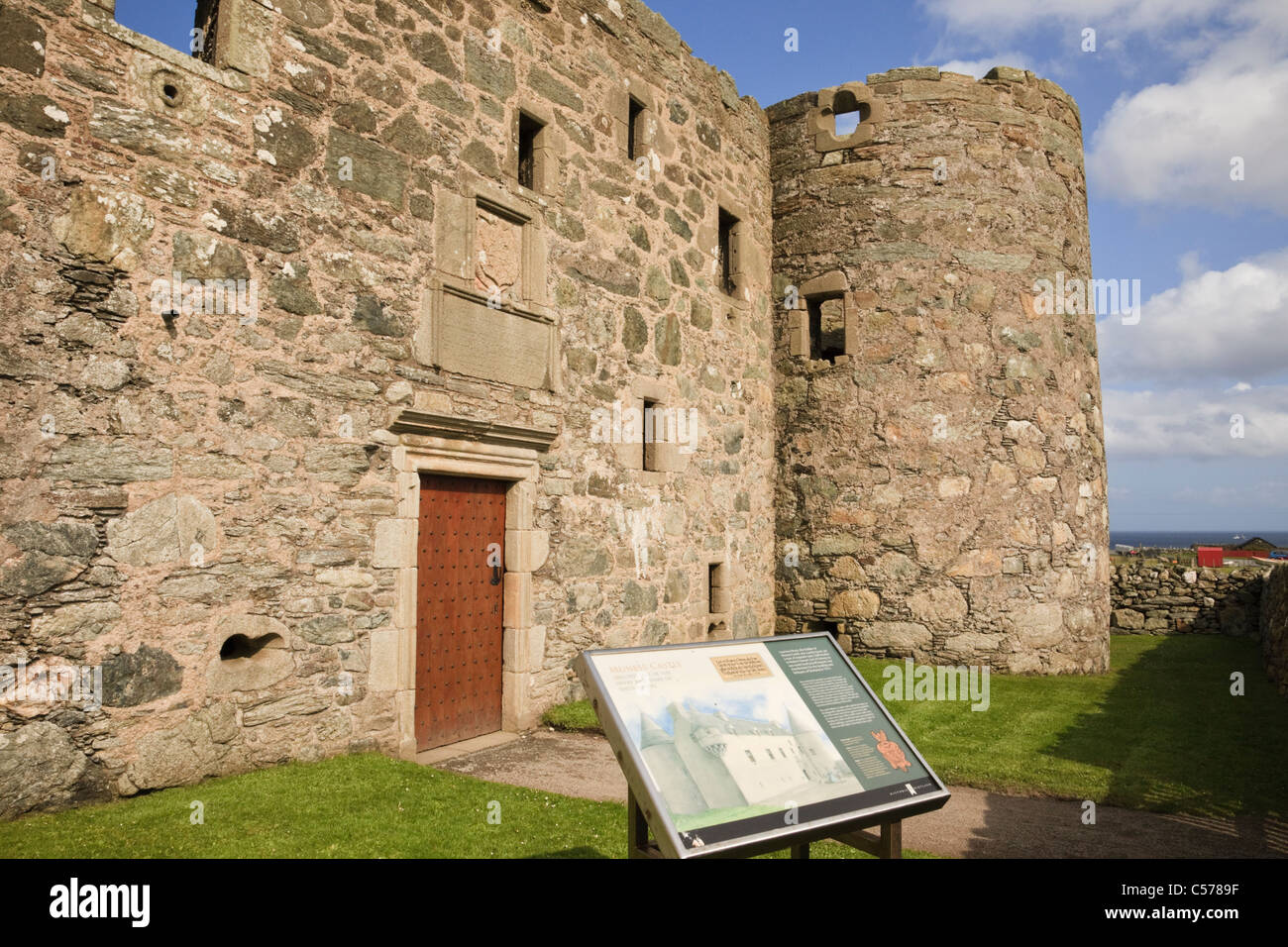 16th century medieval Muness Castle entrance door and information board ...