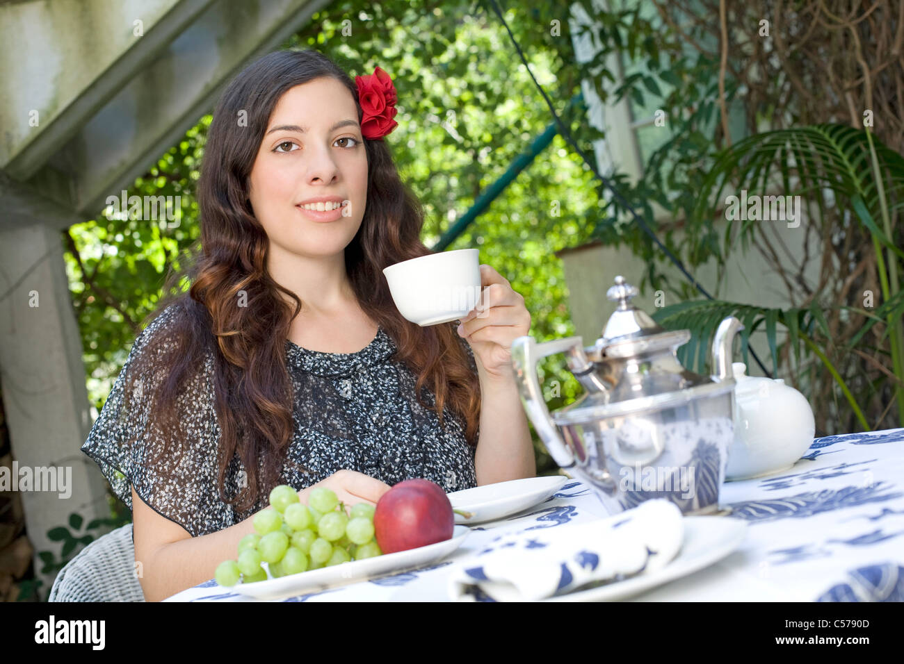 young woman drinking tea in garden Stock Photo - Alamy