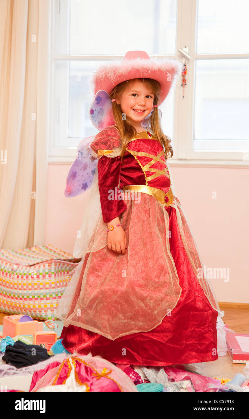 Smiling girl playing dress up Stock Photo - Alamy
