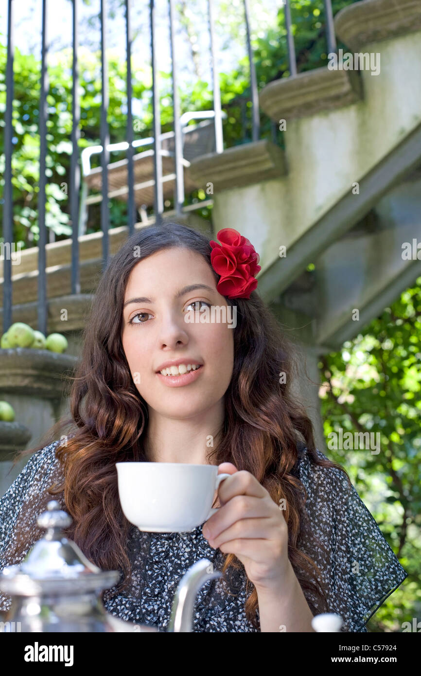 young woman drinking tea in garden Stock Photo - Alamy