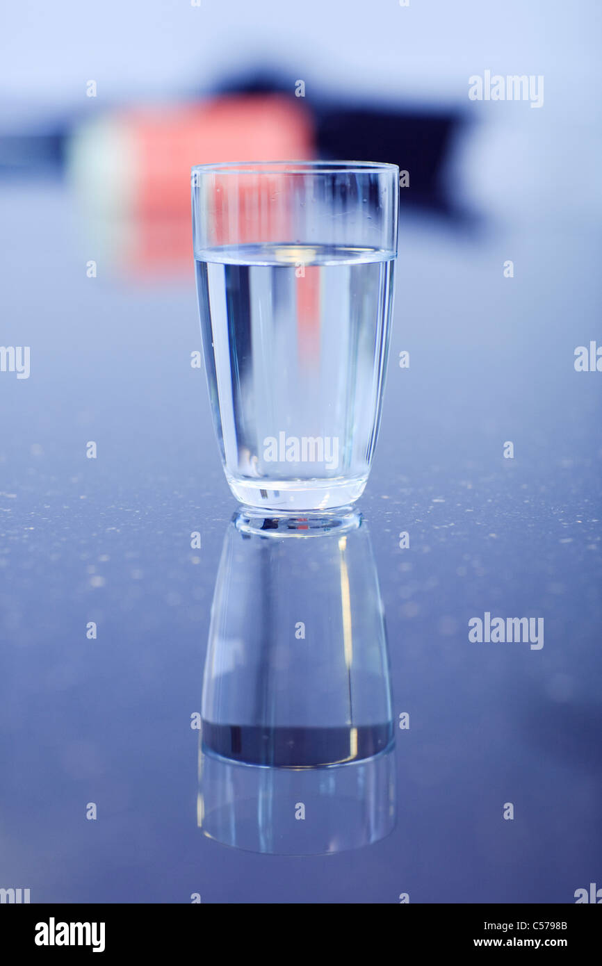 Glass of water on office desk Stock Photo - Alamy