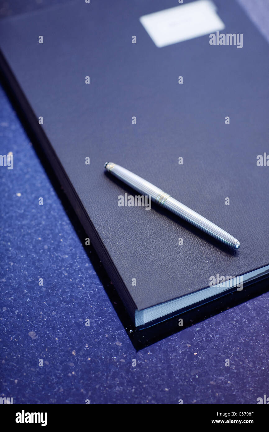 Folder and pen on office desk Stock Photo - Alamy
