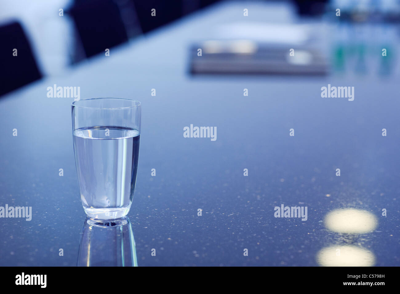 Glass of water on office desk Stock Photo - Alamy