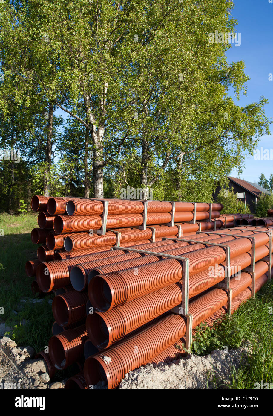 Pile of PVC drainage / sewer pipes waiting for assembly , Finland Stock ...