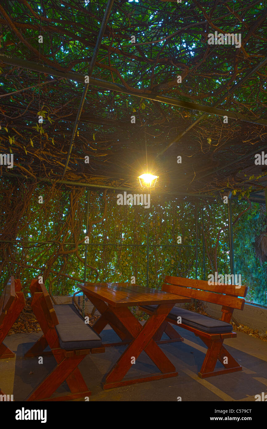 rustic romantic dimly lit wooden sitting group consisting of table and ...