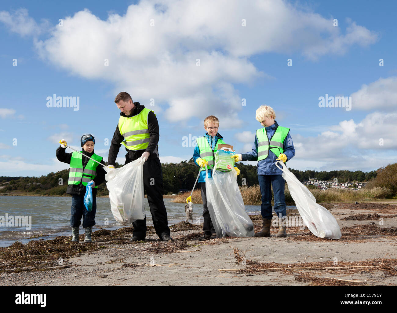 Cleaning a beach family hi-res stock photography and images - Alamy