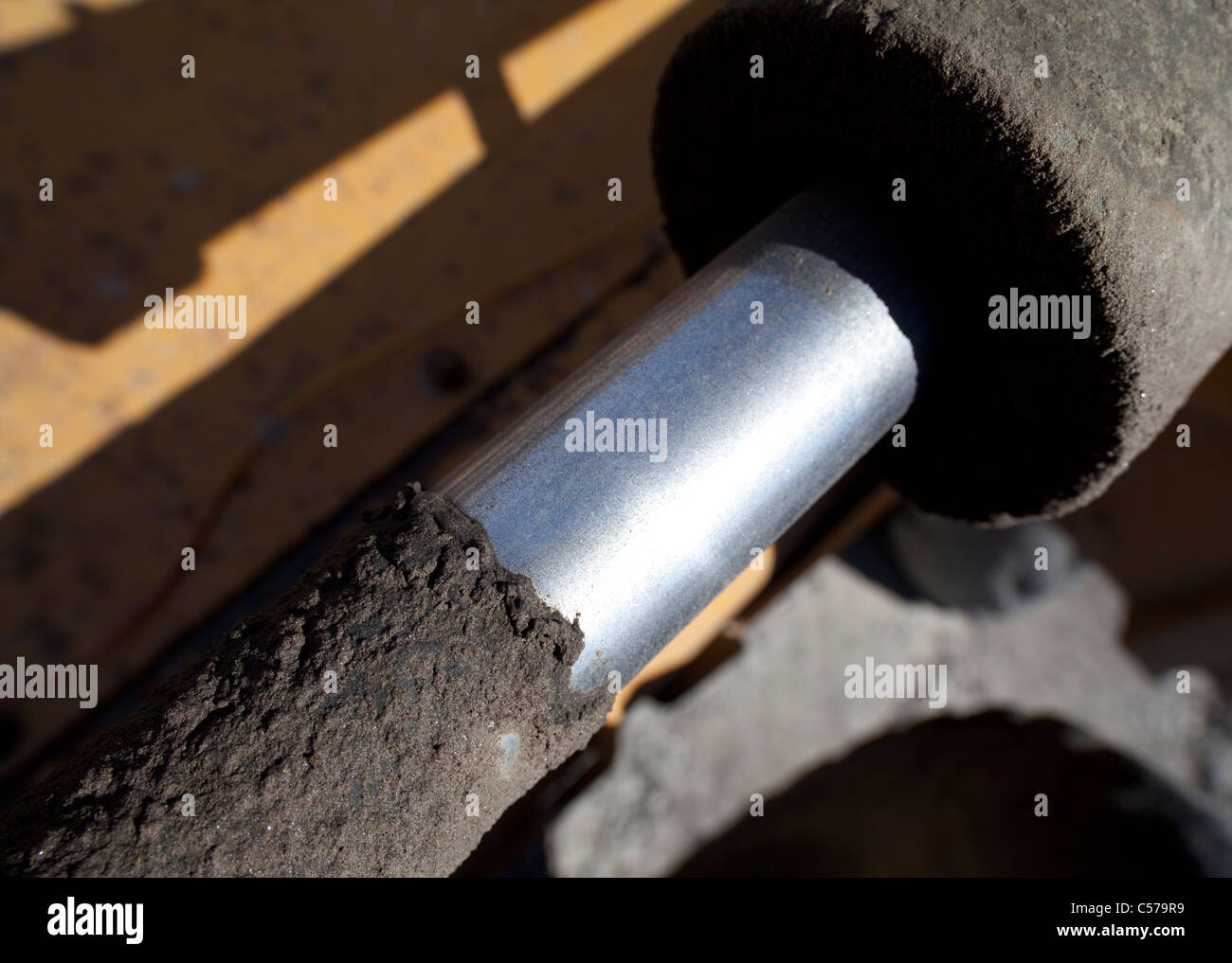 Closeup of greasy and dirty hydraulics cylinder and piston Stock Photo ...