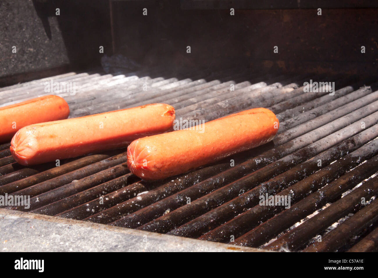 Hot dogs on a bbq Stock Photo - Alamy