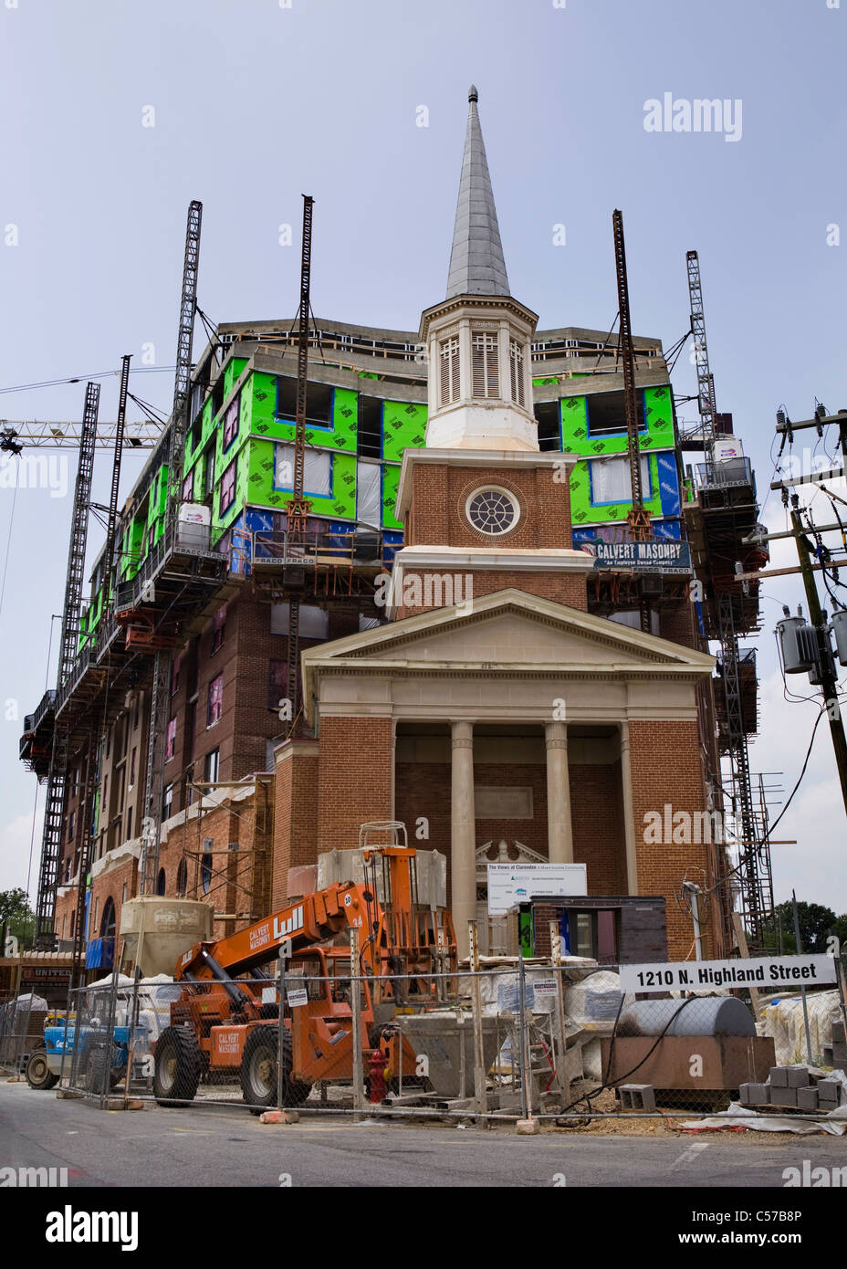 Urban church building remodeling construction with original steeple ...