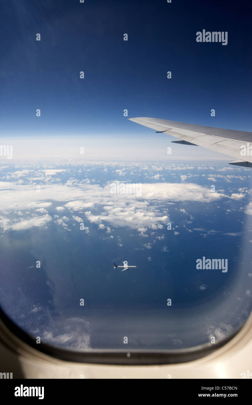 looking out aircraft window at delta airlines flight flying close below ...