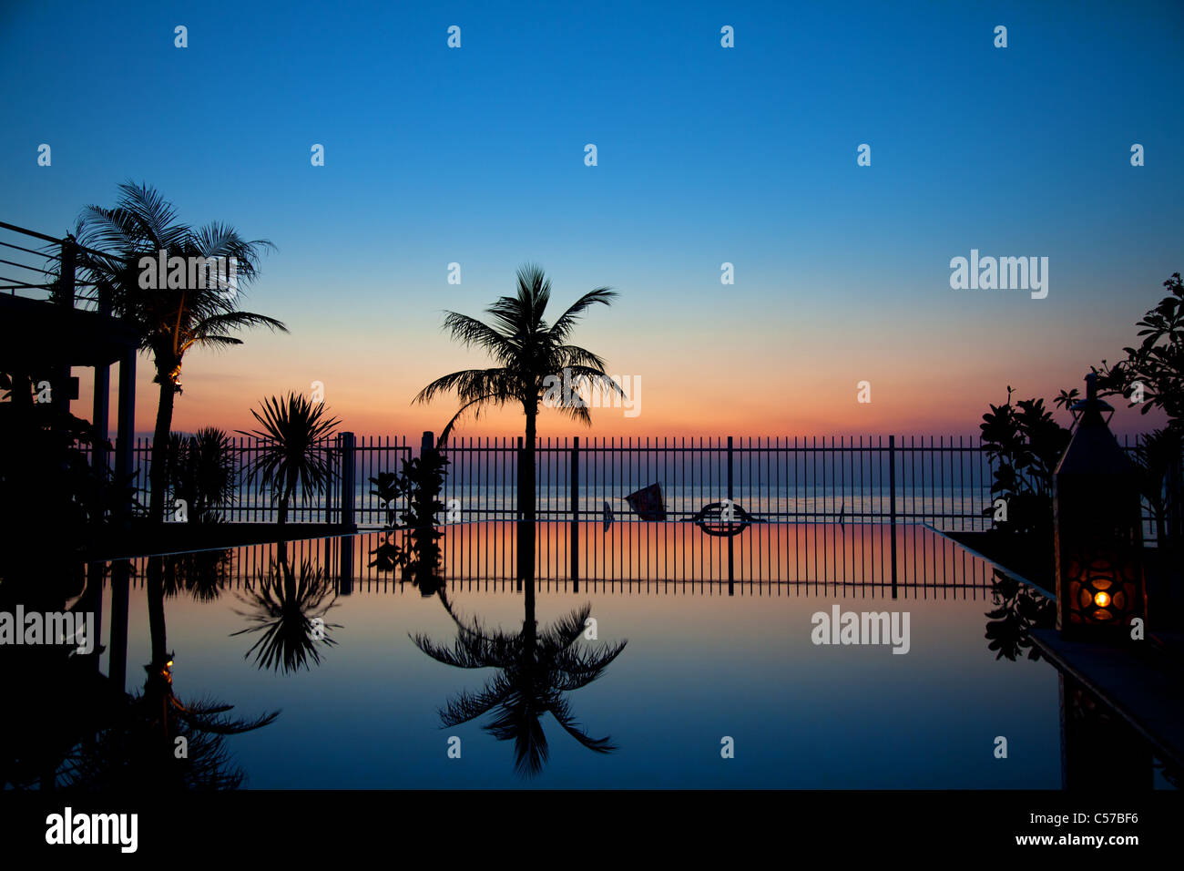 Stunning sunset with a reflection in infinity pool Stock Photo - Alamy