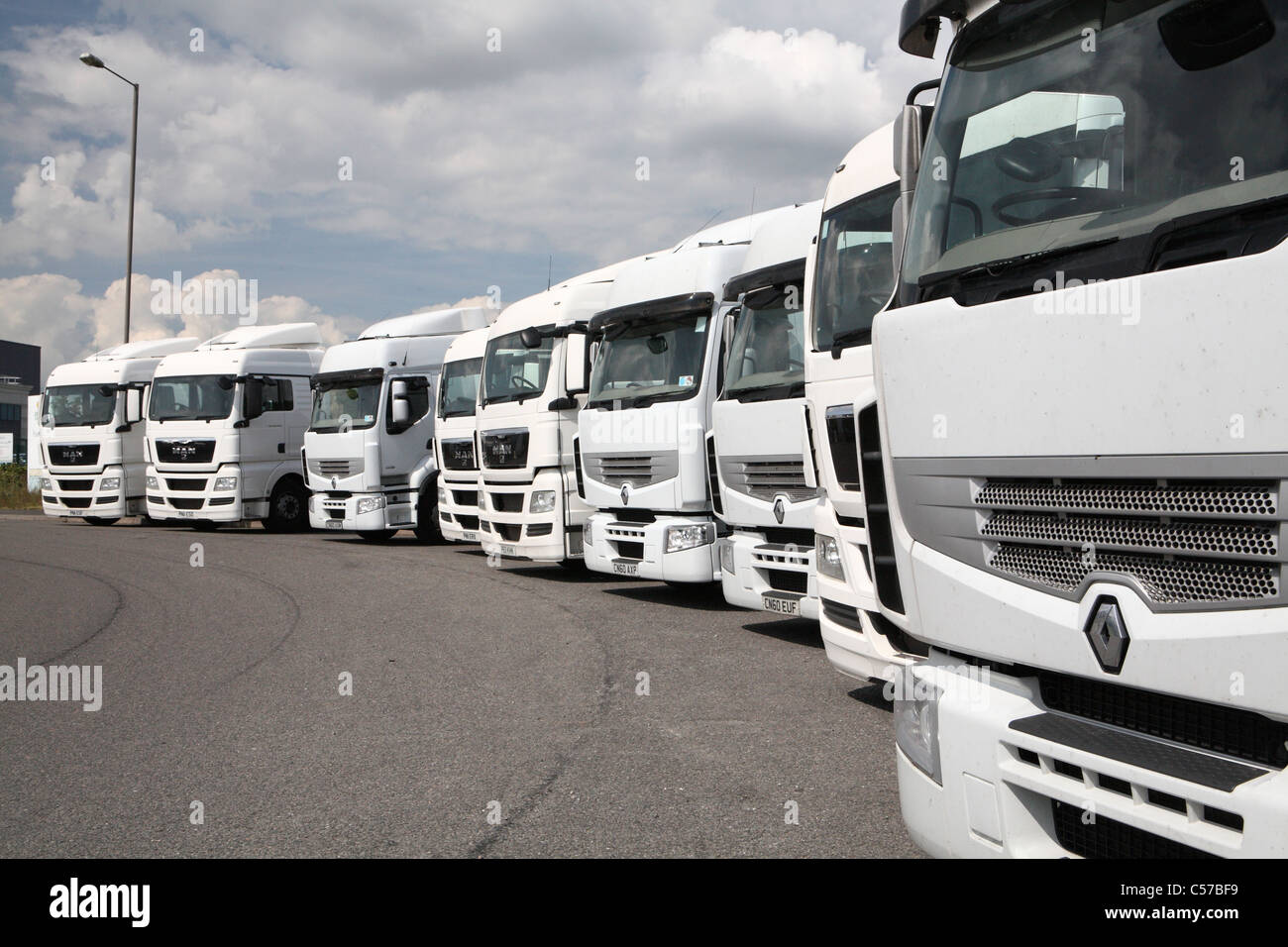 White lorry tractor units distribution depot Stock Photo - Alamy