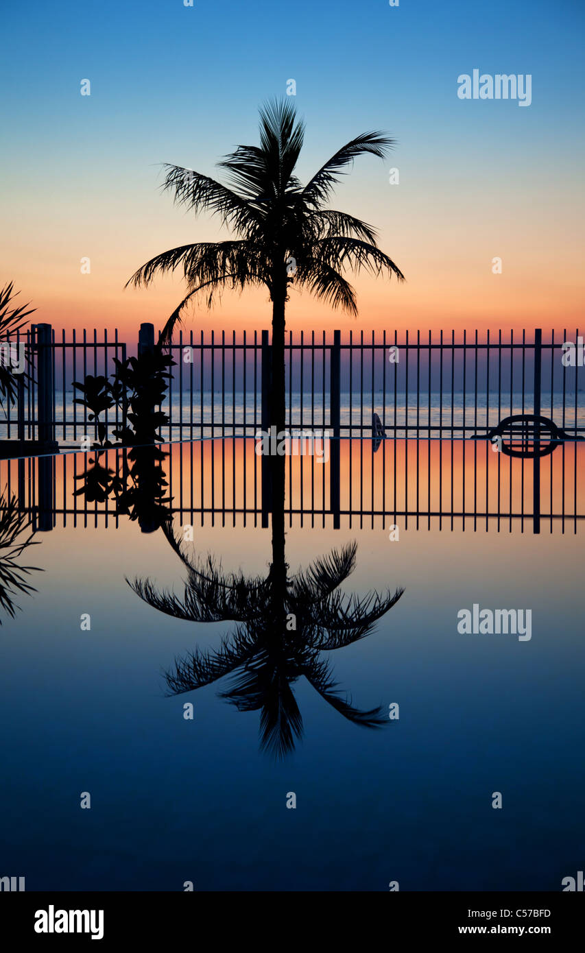 Stunning sunset with a reflection in infinity pool Stock Photo - Alamy