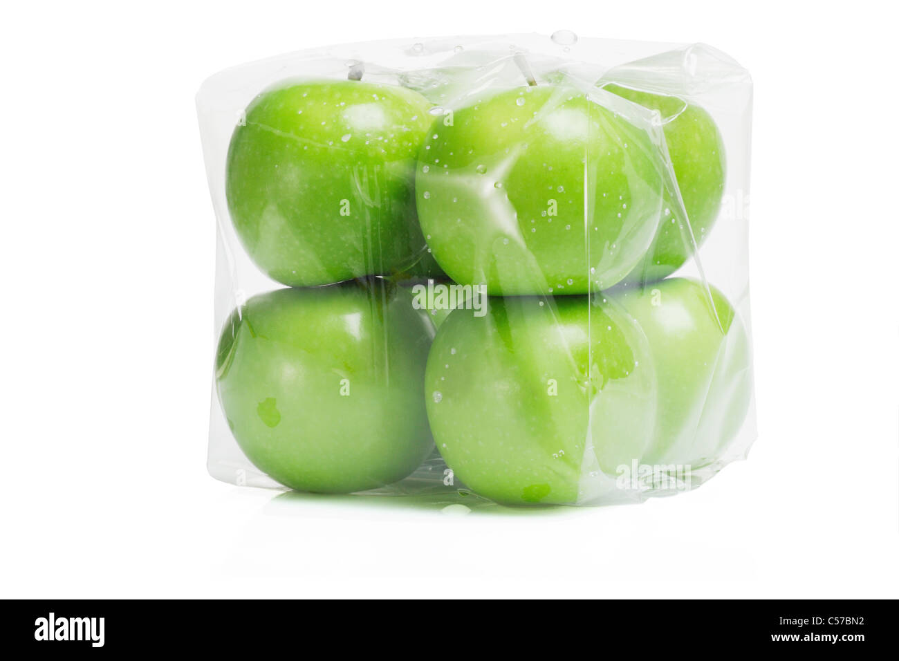Fresh green apples in transparent packing on white background Stock ...