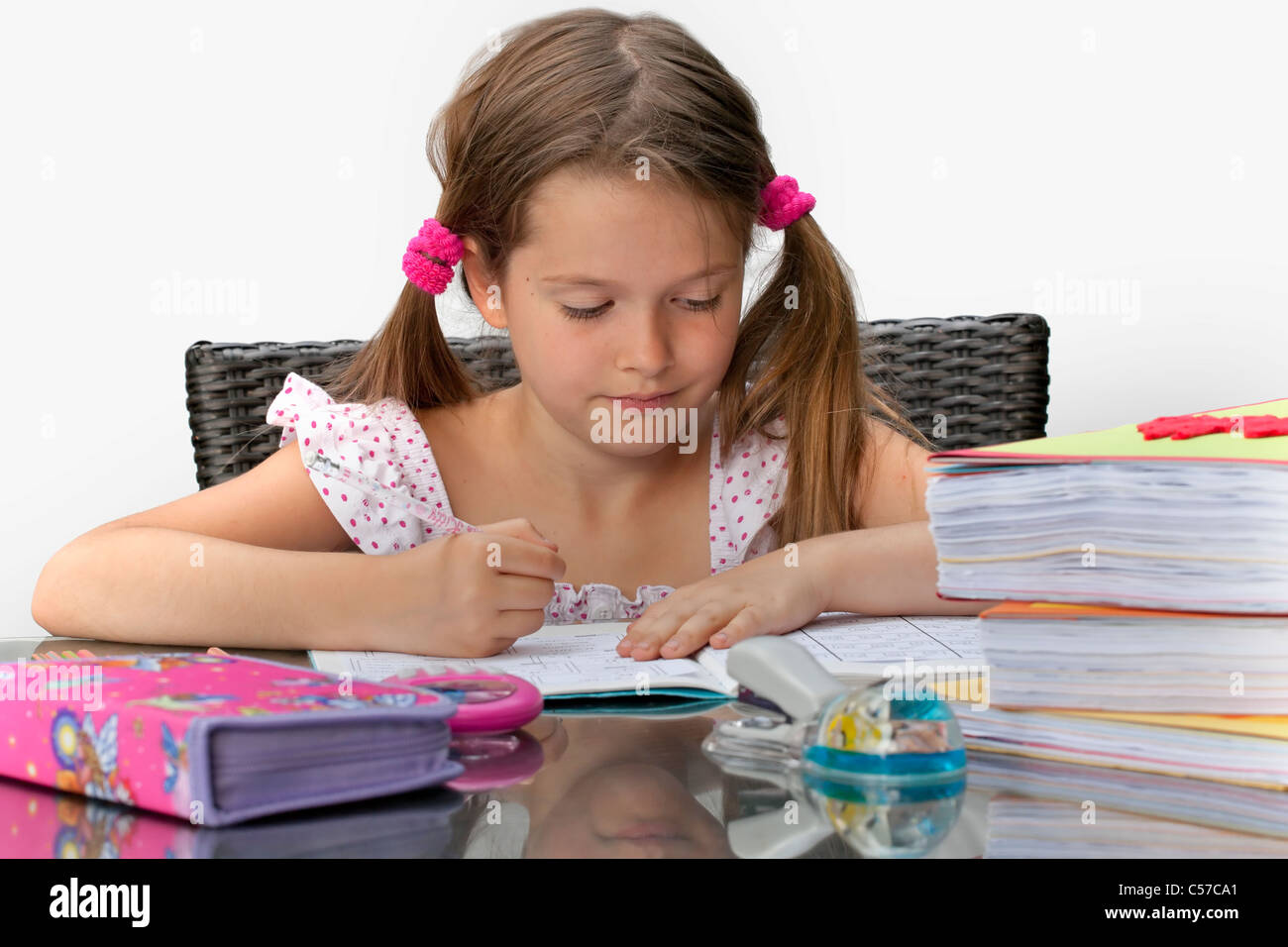 7 year old girl at the table with homework Stock Photo - Alamy