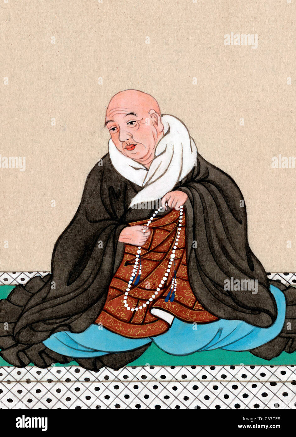 Buddhist monk, seated, facing slightly left, holding a loop of prayer ...