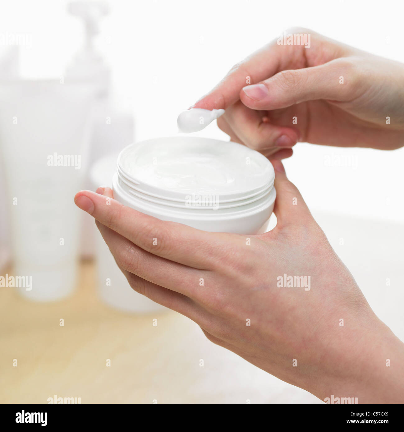 using cosmetics with hands Stock Photo - Alamy