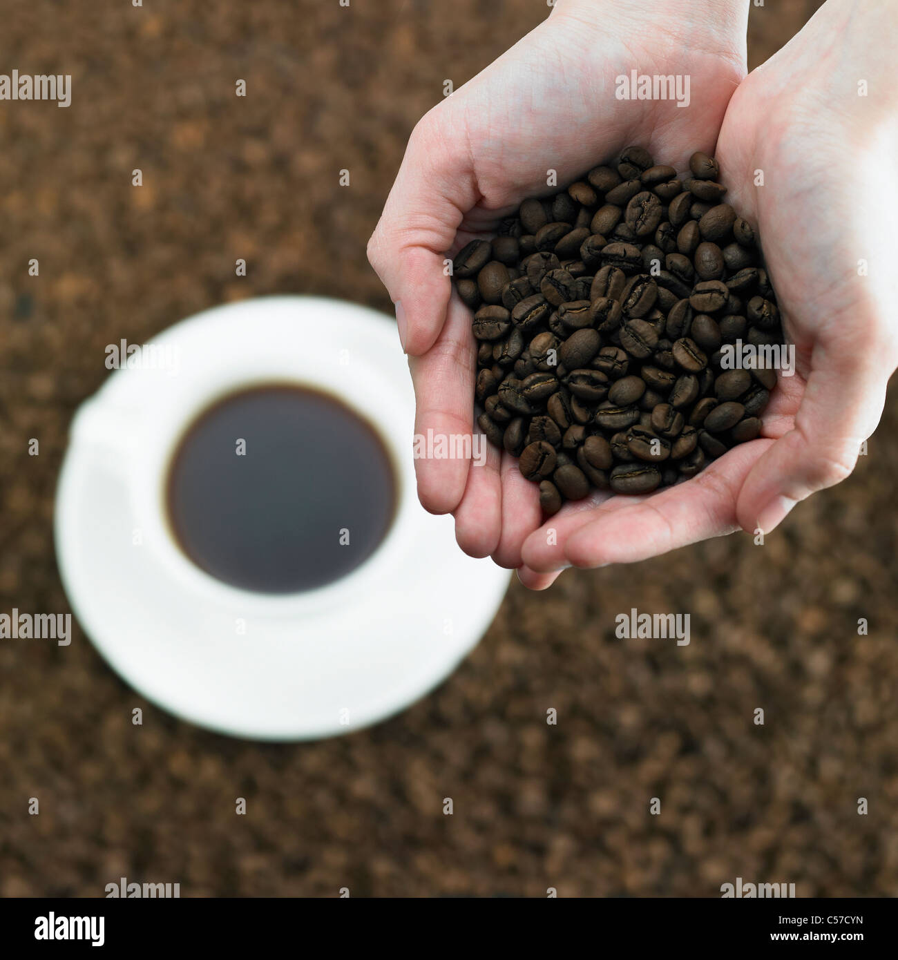 full hands of coffee beans and coffee Stock Photo - Alamy