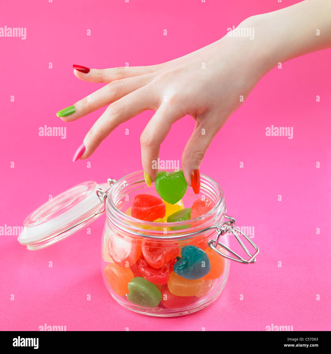 vivid colored nail hand grip the candies Stock Photo - Alamy