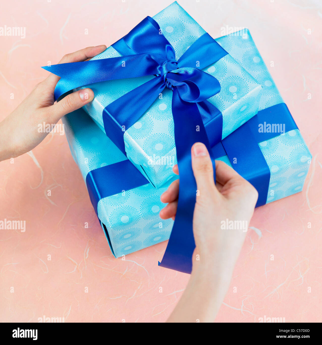 hands tie a package with ribbon Stock Photo - Alamy