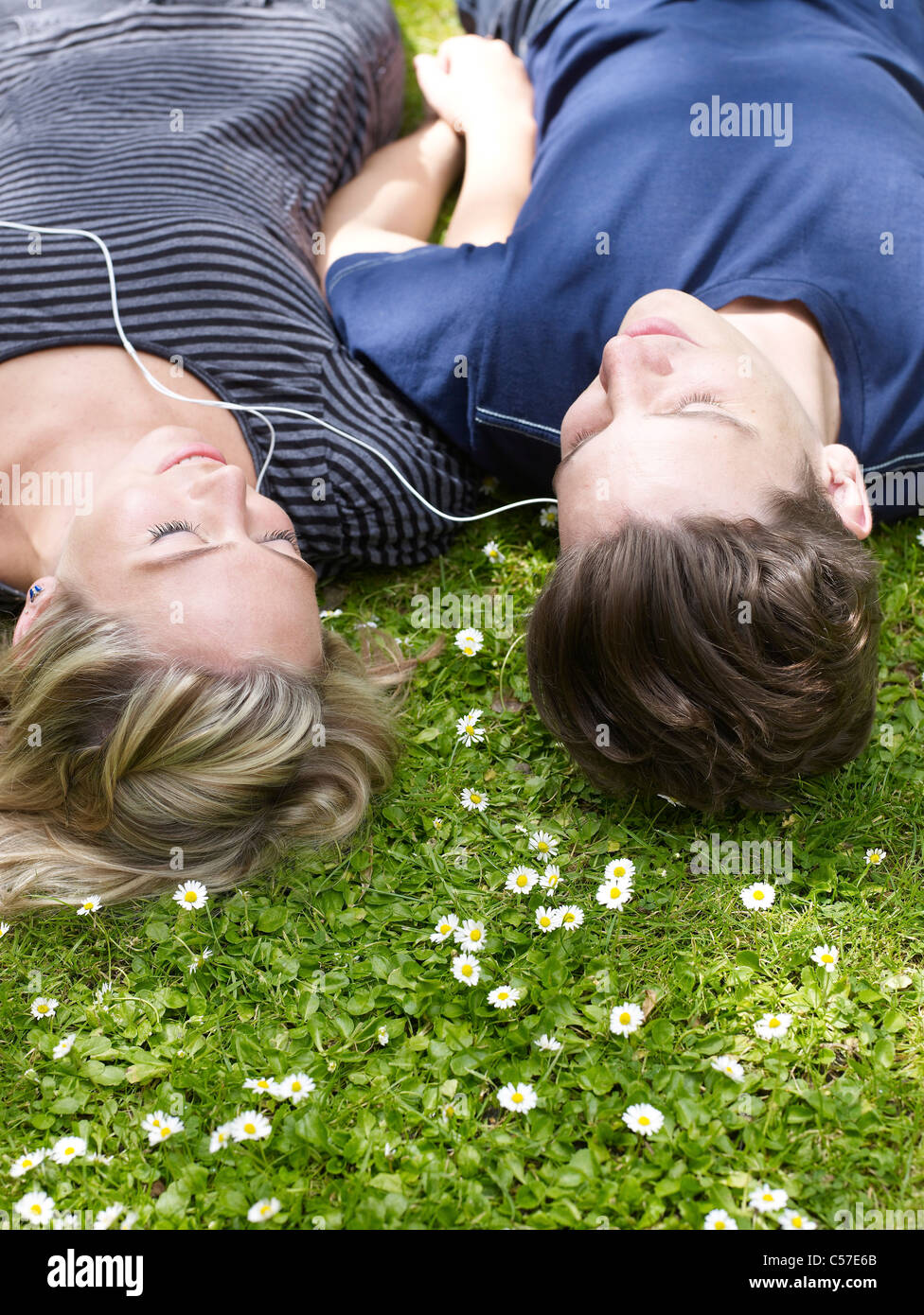 Couple listening to headphones together Stock Photo - Alamy