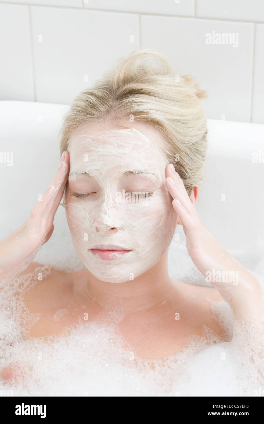 Woman wearing mask in bubble bath Stock Photo - Alamy