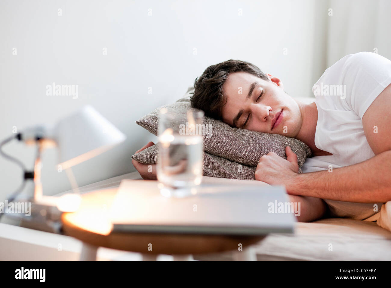 Man asleep in bed Stock Photo - Alamy