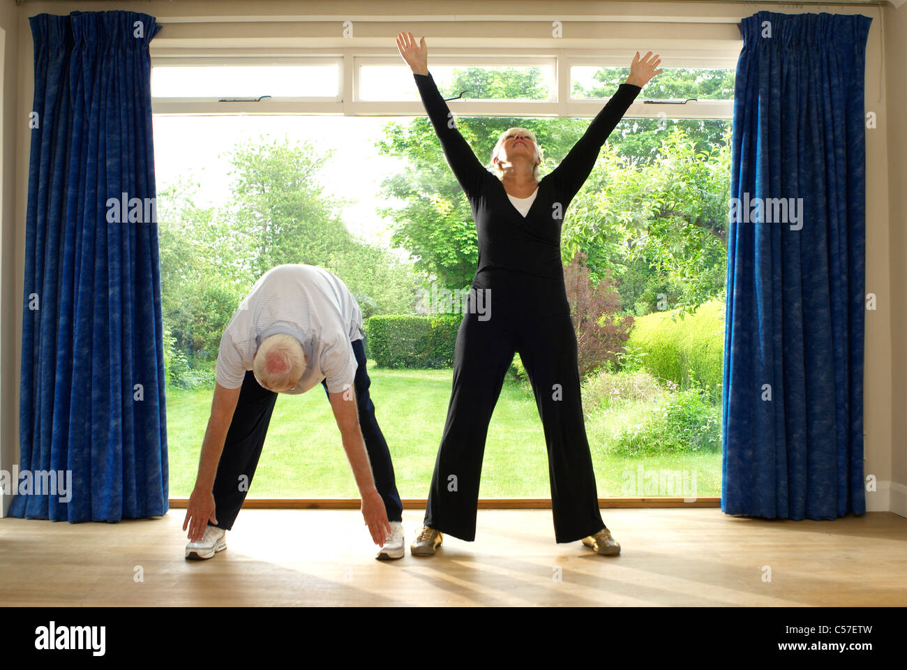 Couple stretching together indoors Stock Photo - Alamy