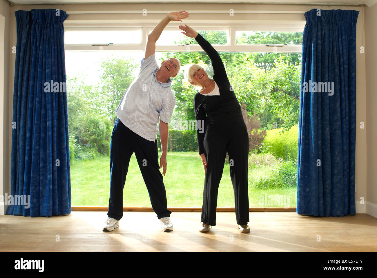 Couple stretching together indoors Stock Photo - Alamy