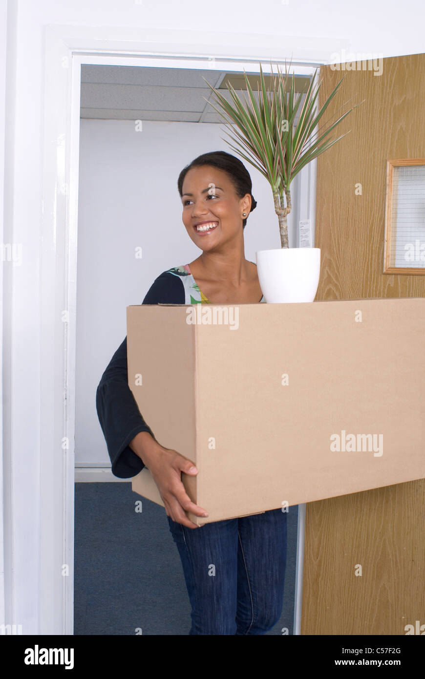 Woman carrying large cardboard box hi-res stock photography and images ...