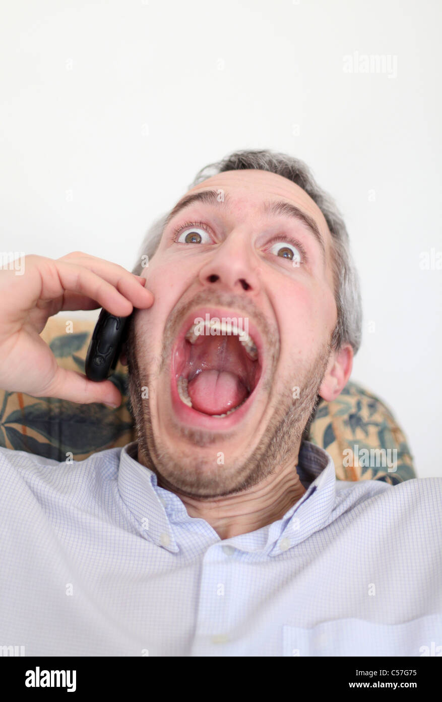Man on a mobile phone laughing uncontrollably. Picture by James ...
