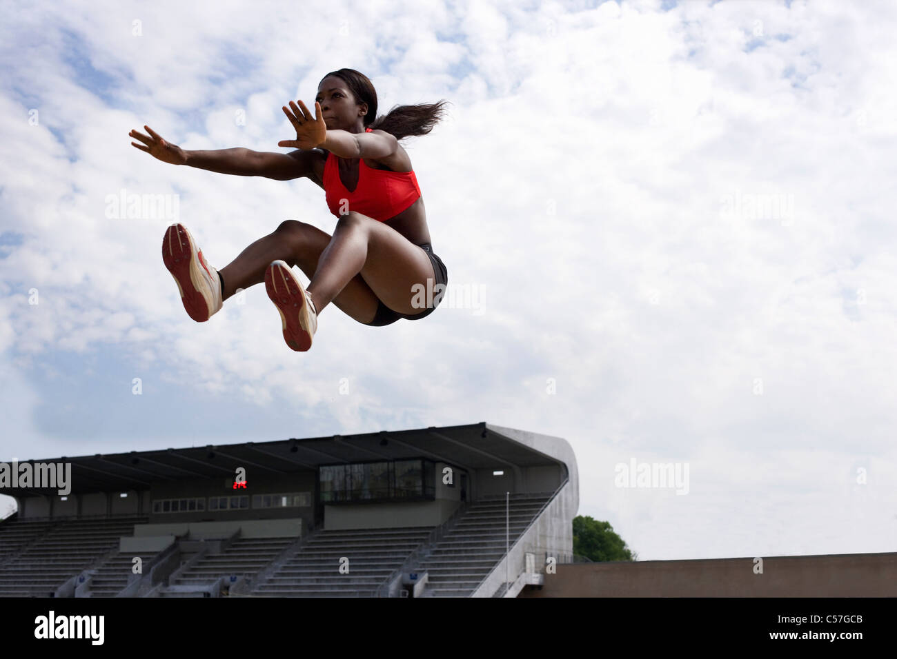 Athlete in midair during long jump Stock Photo - Alamy