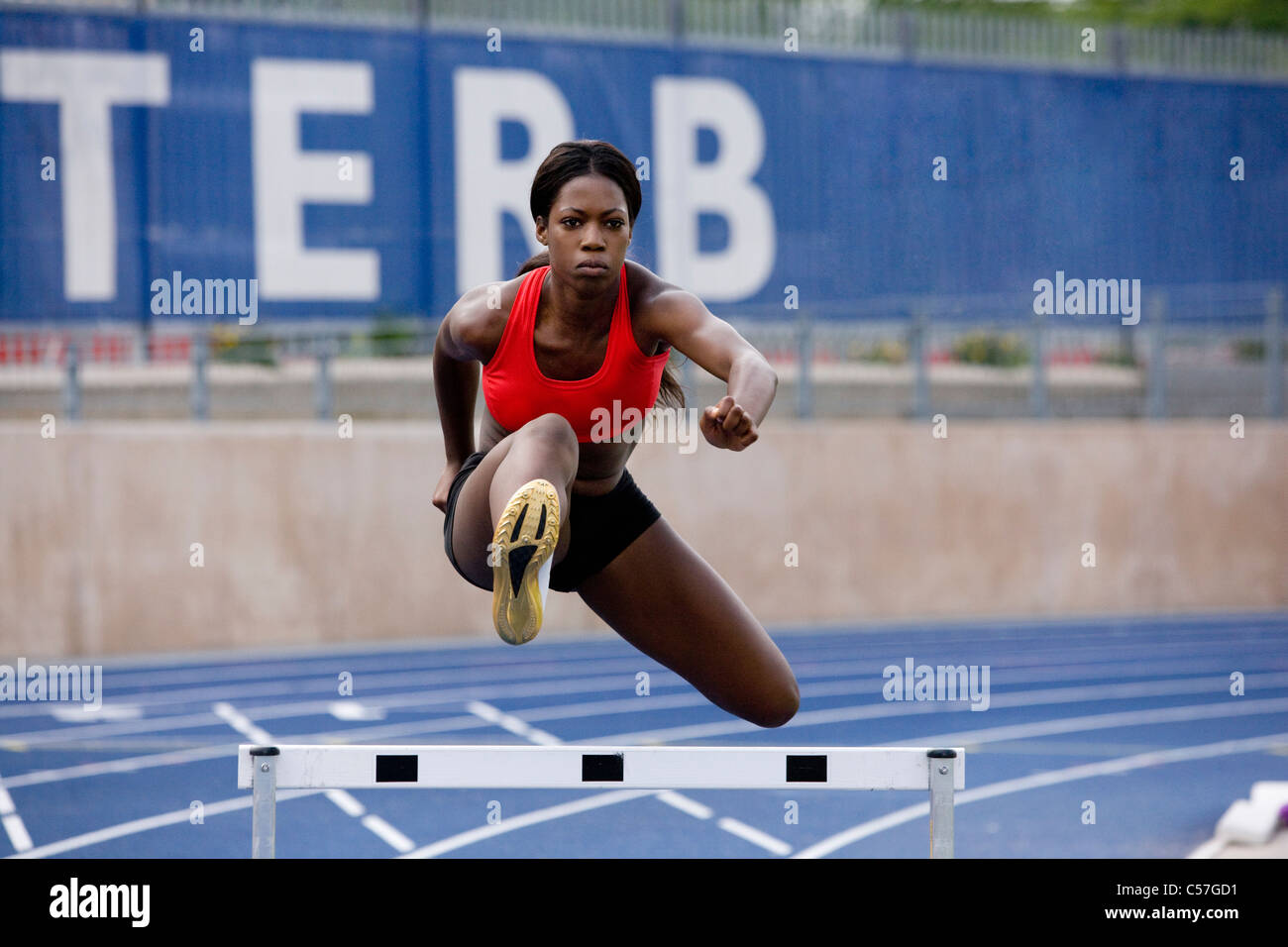 Girl jumping hurdle on running hi-res stock photography and images - Alamy