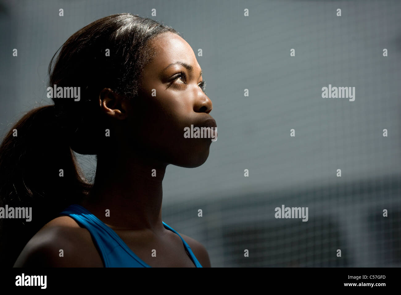 Woman looking up into light Stock Photo - Alamy