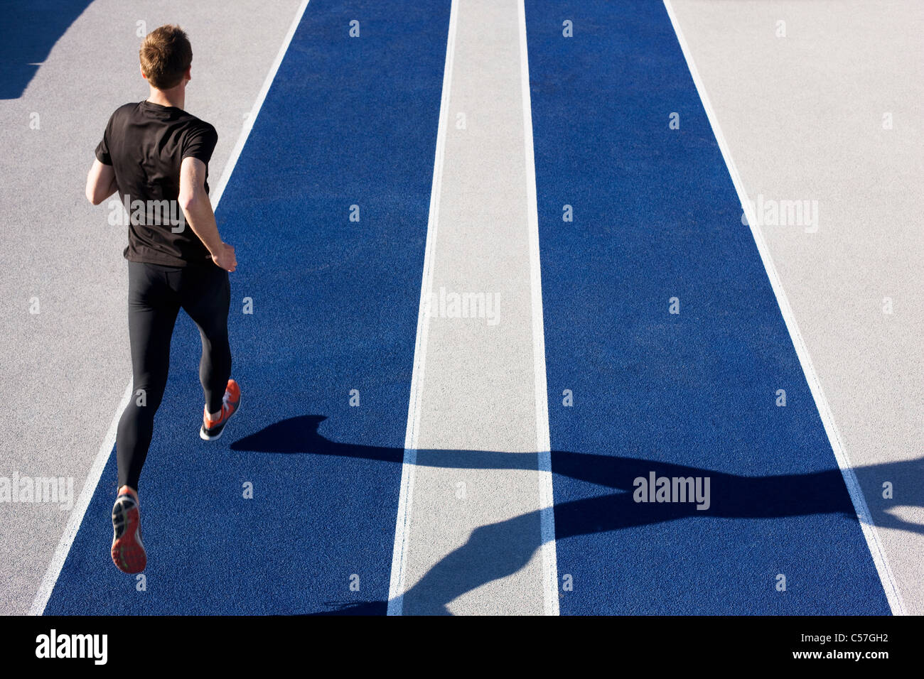 Man running on track Stock Photo - Alamy