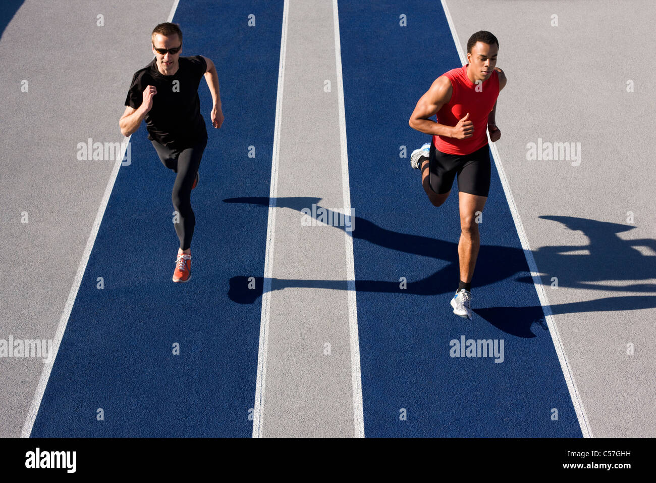 Runners racing on track Stock Photo - Alamy