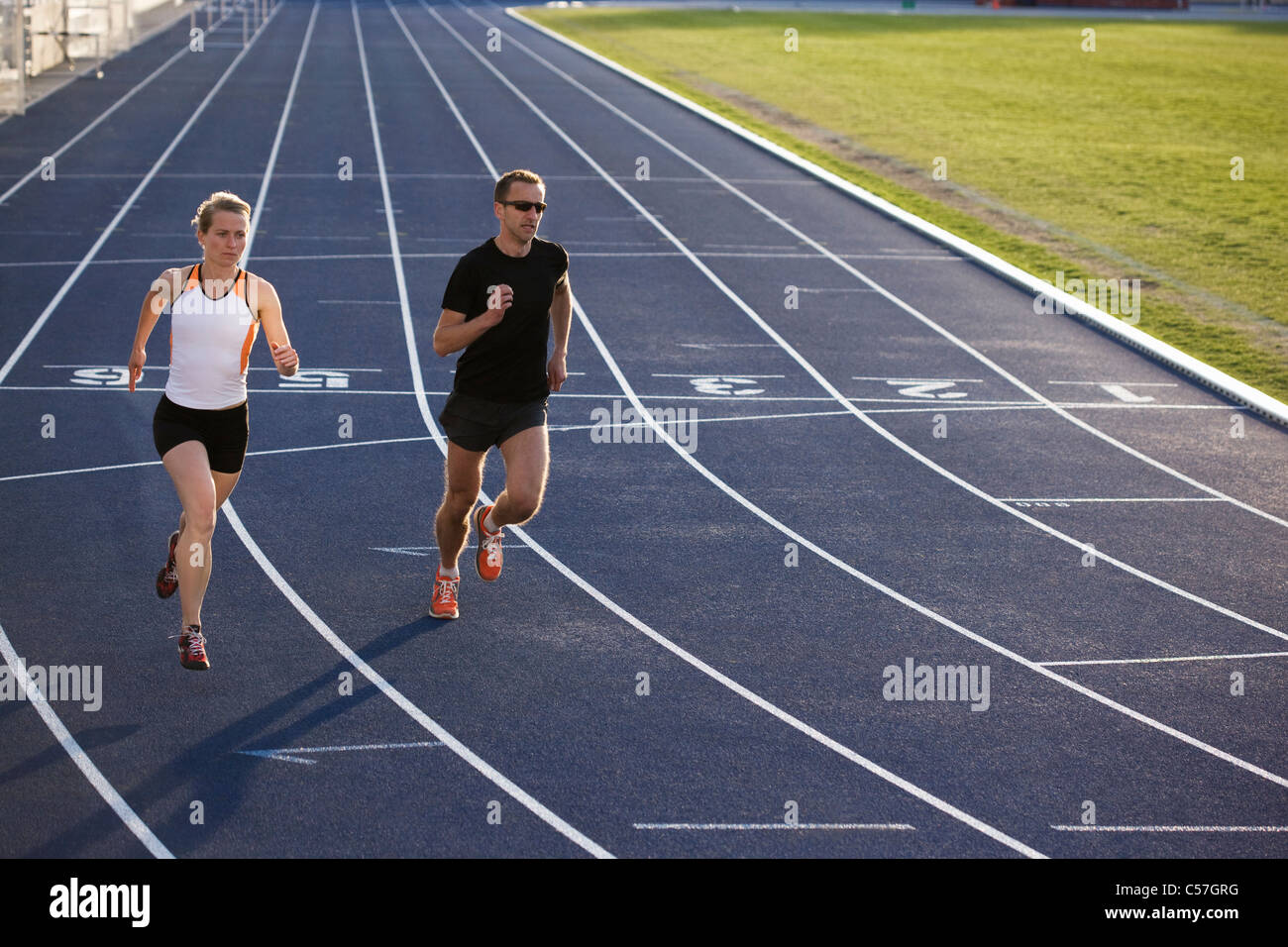 Runners racing on track Stock Photo - Alamy