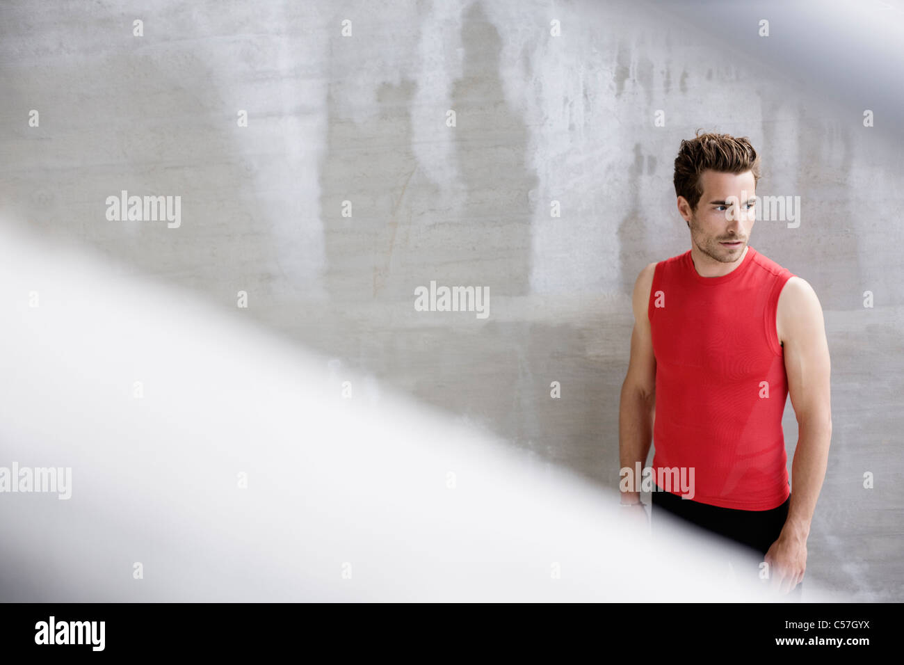 Man standing near wall Stock Photo - Alamy