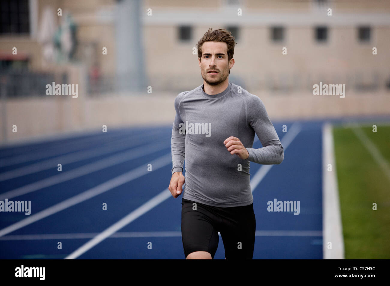 Man running on track Stock Photo - Alamy