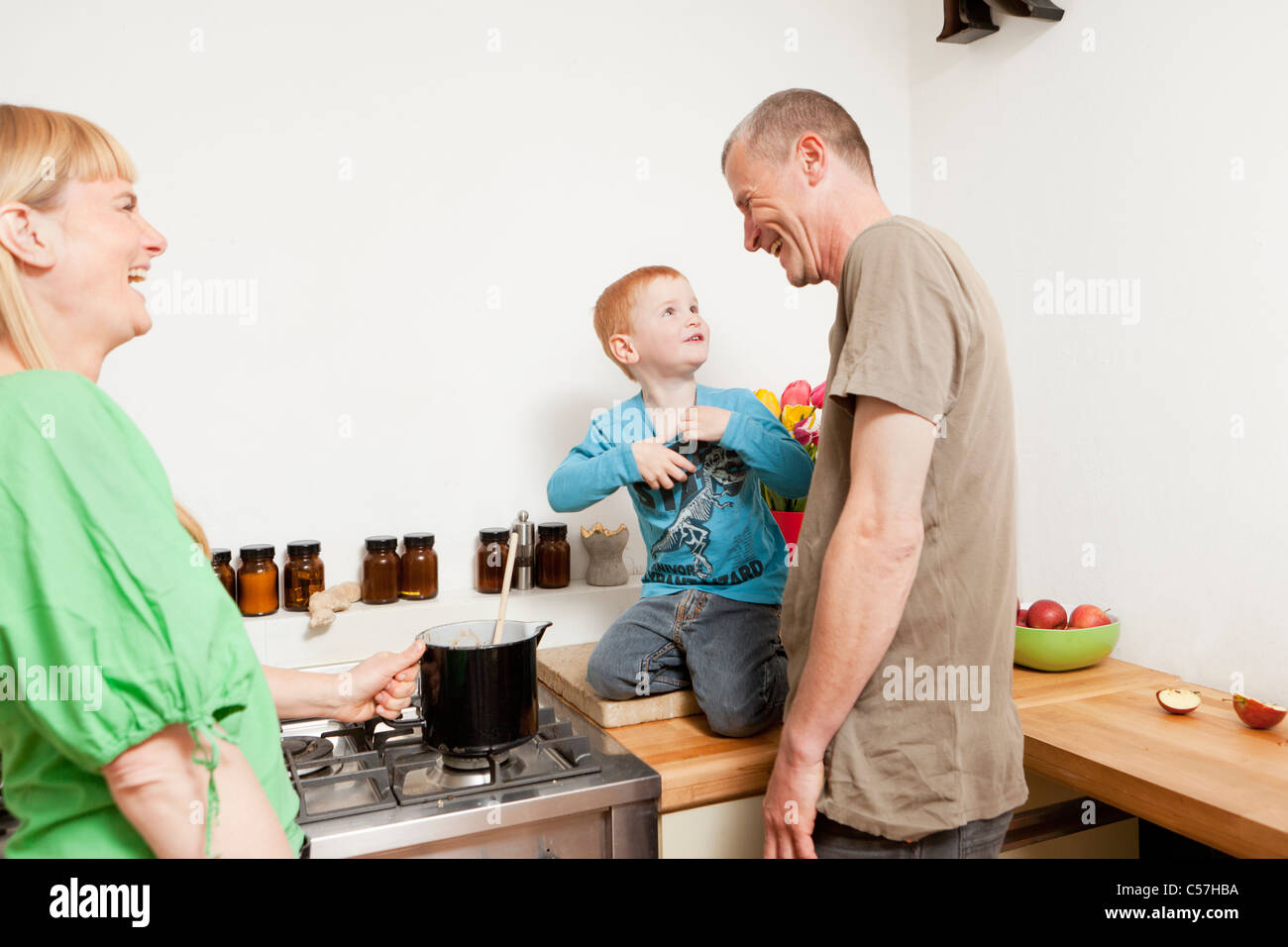 Family cooking together in kitchen Stock Photo - Alamy