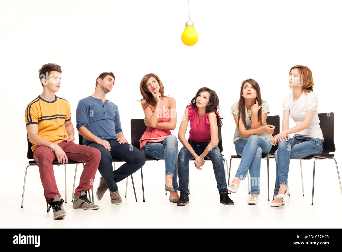 group of friends pondering over a light bulb Stock Photo - Alamy