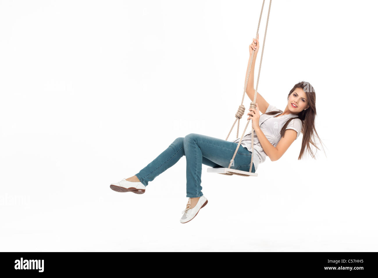 young woman swinging alone on a swing Stock Photo - Alamy
