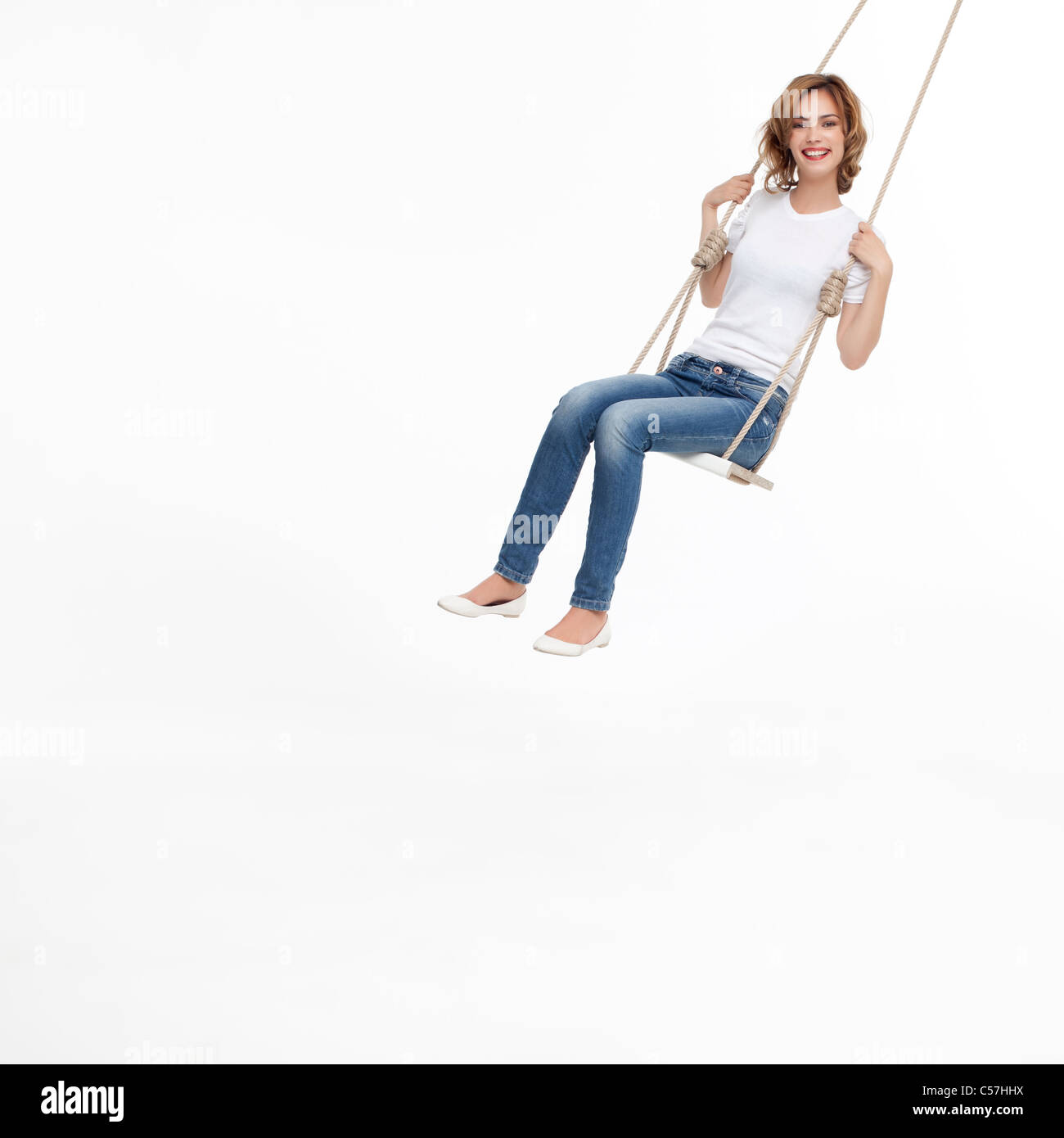 young woman swinging alone on a swing Stock Photo - Alamy