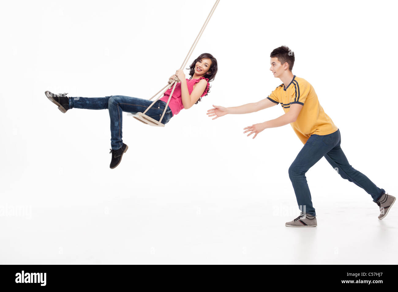 young handsome man pushing his girlfriend on a swing Stock Photo - Alamy young handsome man pushing his girlfriend on a swing Stock Photo - Alamy