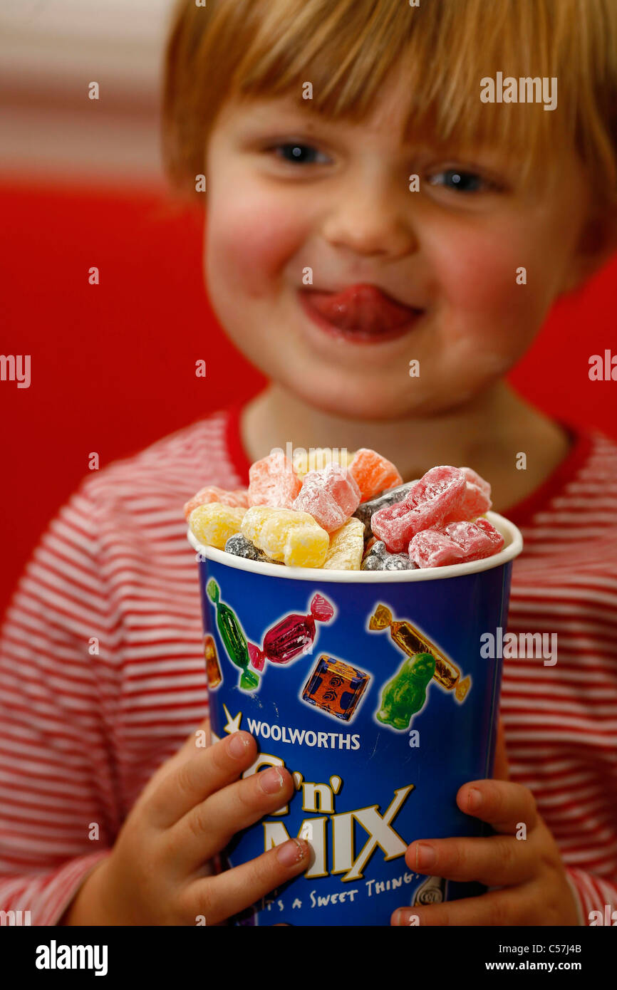 Cute little girl eating sweets. Picture by James Boardman Stock Photo ...