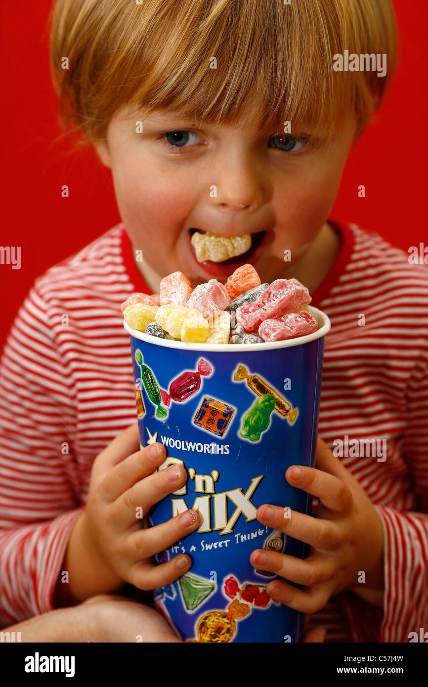 Cute little girl eating sweets. Picture by James Boardman Stock Photo ...