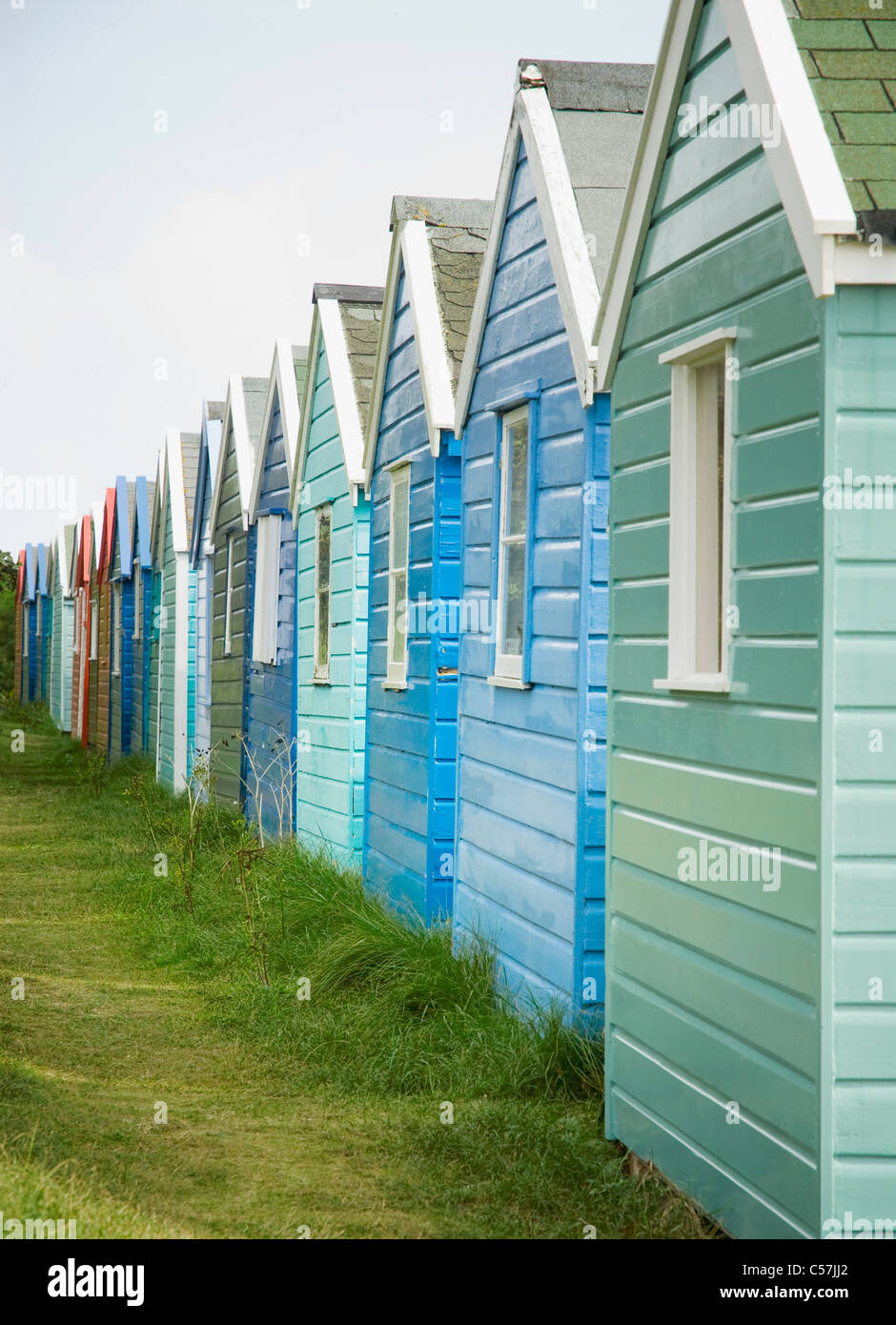 Brightly colored huts on beach Stock Photo - Alamy