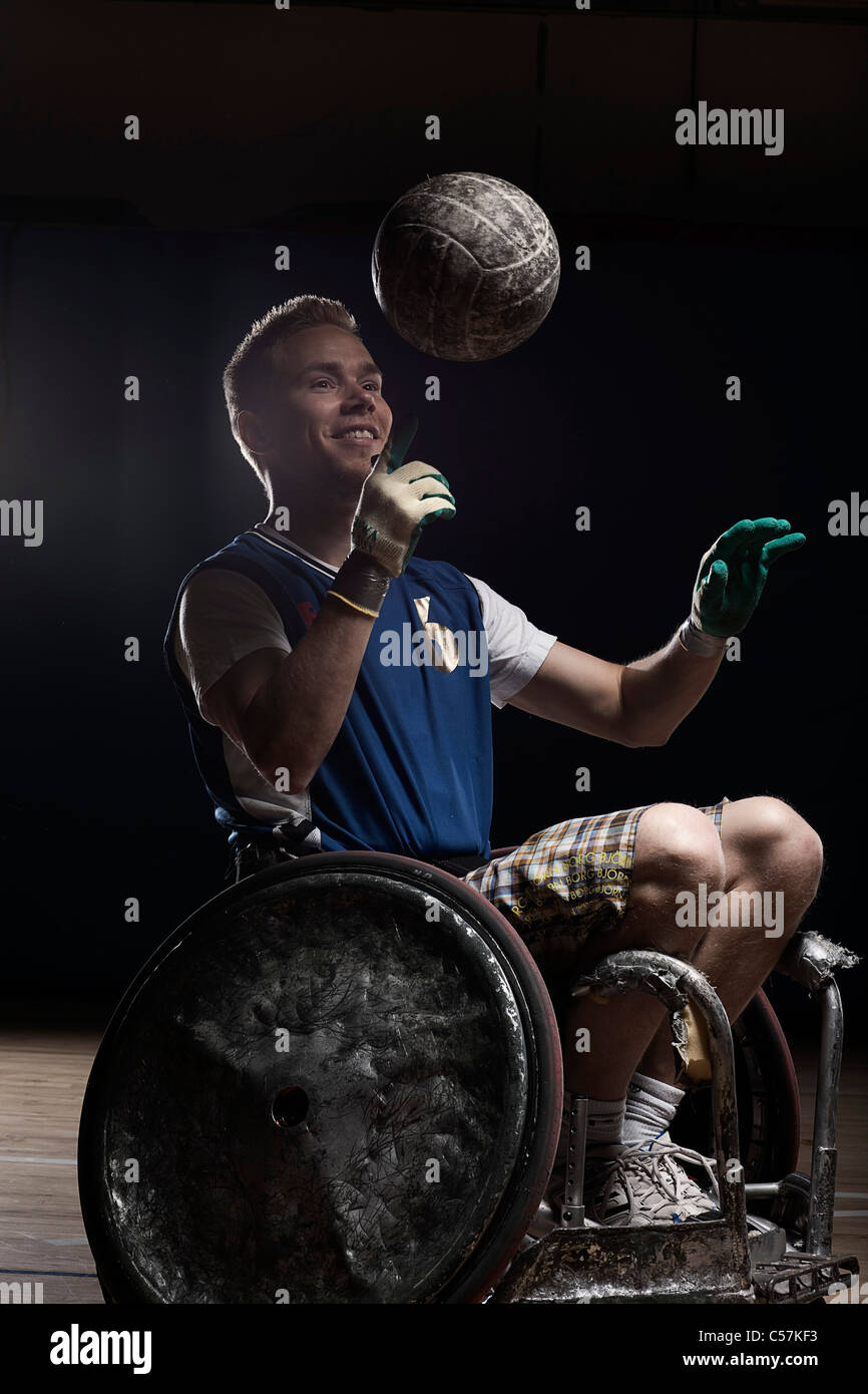 Rugby player in wheelchair with ball Stock Photo - Alamy