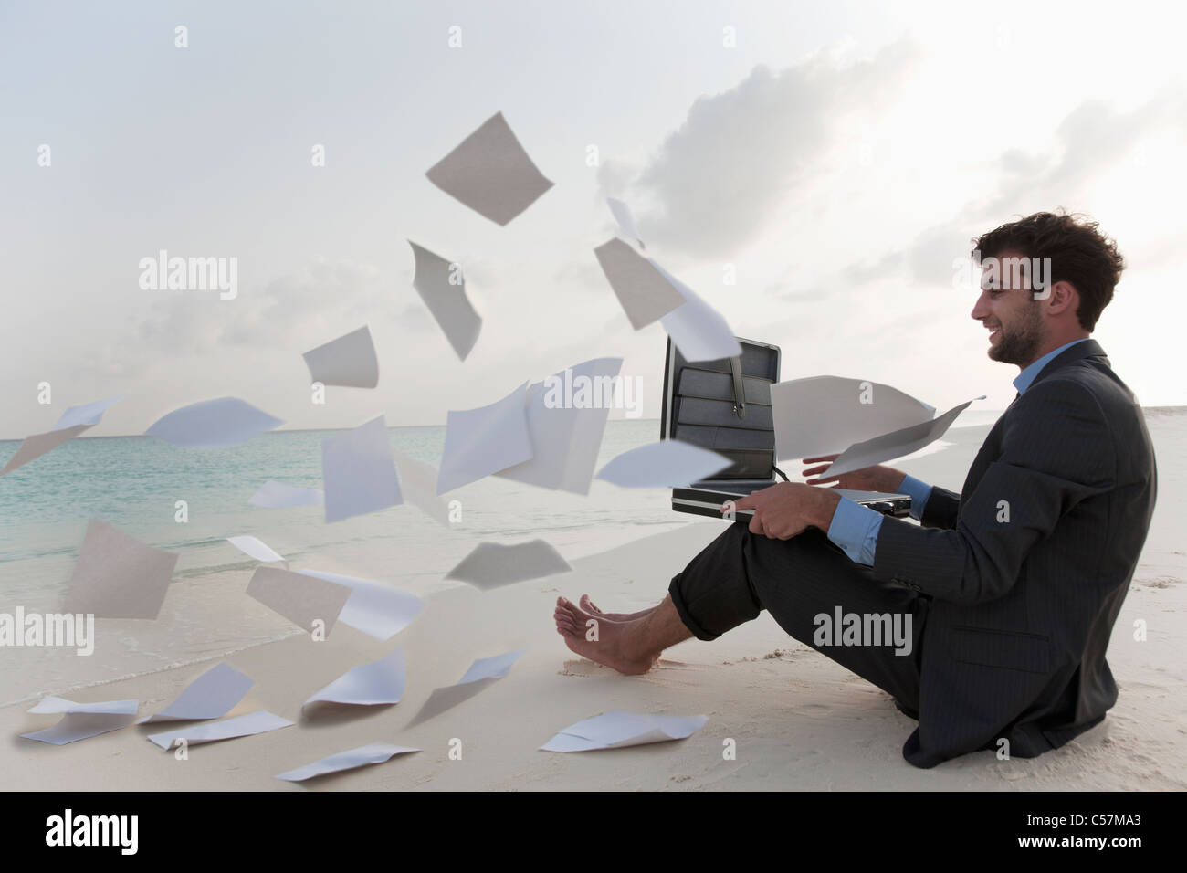 Businessman’s documents flying in wind Stock Photo - Alamy